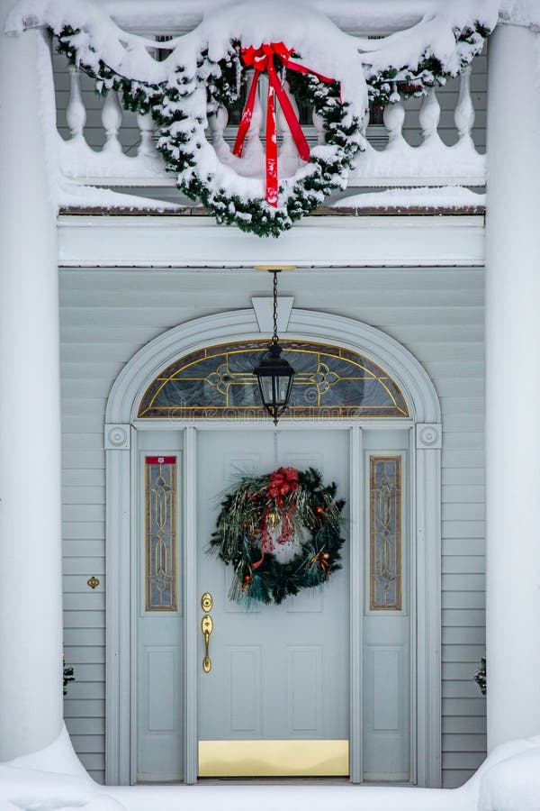 Gold and White Front Door Decorated with Christmas Decorations and Snow ...