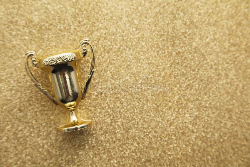 Gold Winners Achievement Trophy on a Gold Glitter Background Stock ...