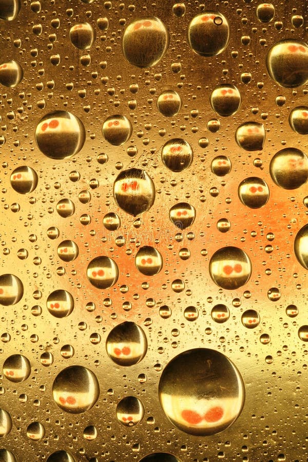 Golden Amber Water Drops stock image. Image of drink, shape - 4683827