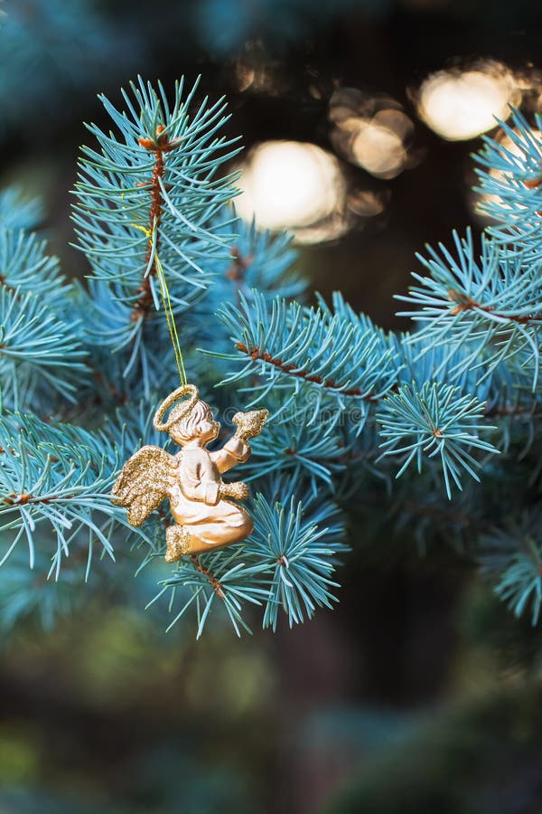 Golden Angel with a Bird on Blue Spruce. Place for Text. Element ...