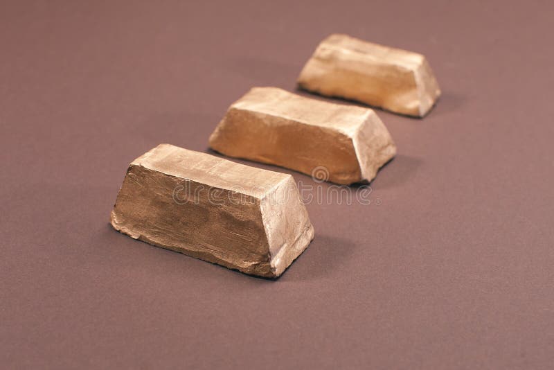 Golden Bars Isolated on Brown Surface Stock Image - Image of mineral ...