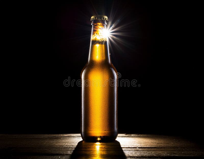 A Golden Beer Bottle Silhouette Glowing Under Spotlight in Complete ...