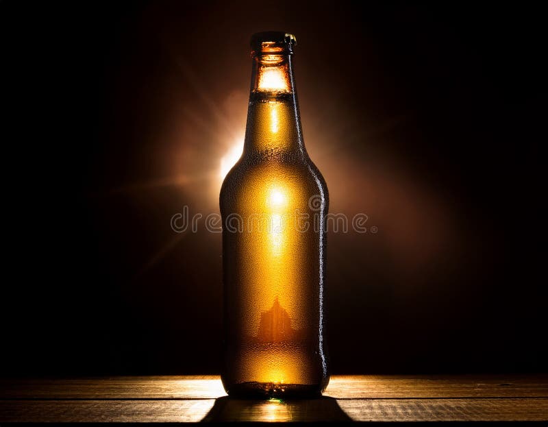 A Golden Beer Bottle Silhouette Glowing Under Spotlight in Complete ...