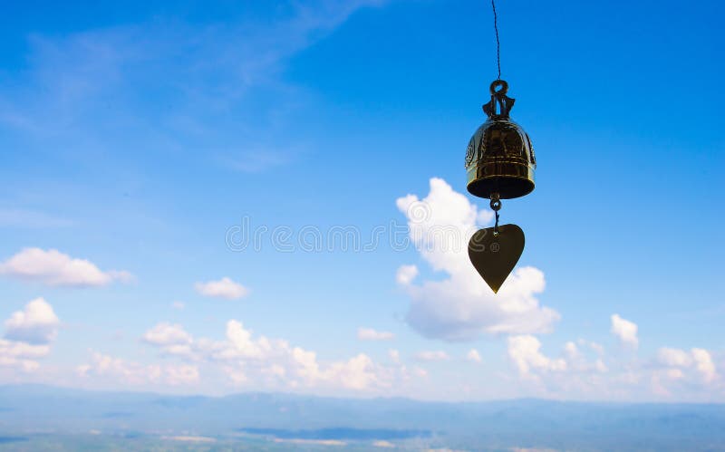 A Golden Bell Hanging Against the Backdrop of Beautiful Sky Stock Photo ...