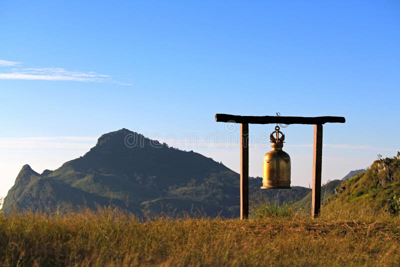Golden Bell Hanging from a Wooden Structure in the Mountains Stock ...