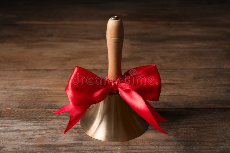 Golden Bell with Red Bow on Wooden Table. School Days Stock Image ...