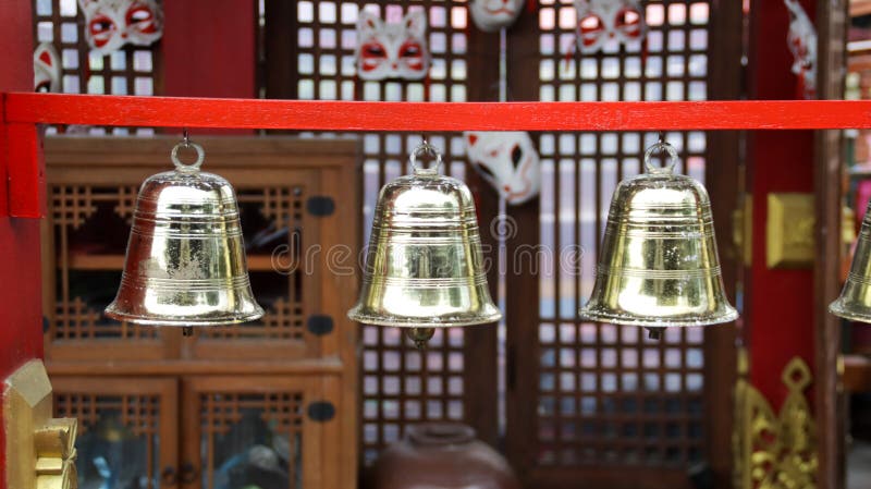 Golden Bells Hanging on Red Frame with Wooden Background in Traditional ...