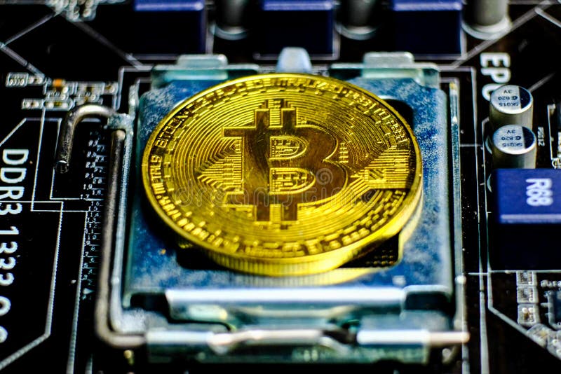 Golden Bitcoin Cryptocurrency Coin on a PC Computer Motherboard Stock ...