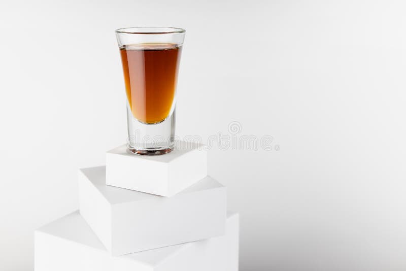Golden Brandy Shot Glass in Hard Light with Shadow, Reflection on High ...