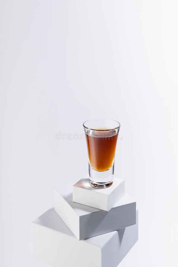 Golden Brandy Shot Glass in Hard Light with Shadow, Reflection on High ...