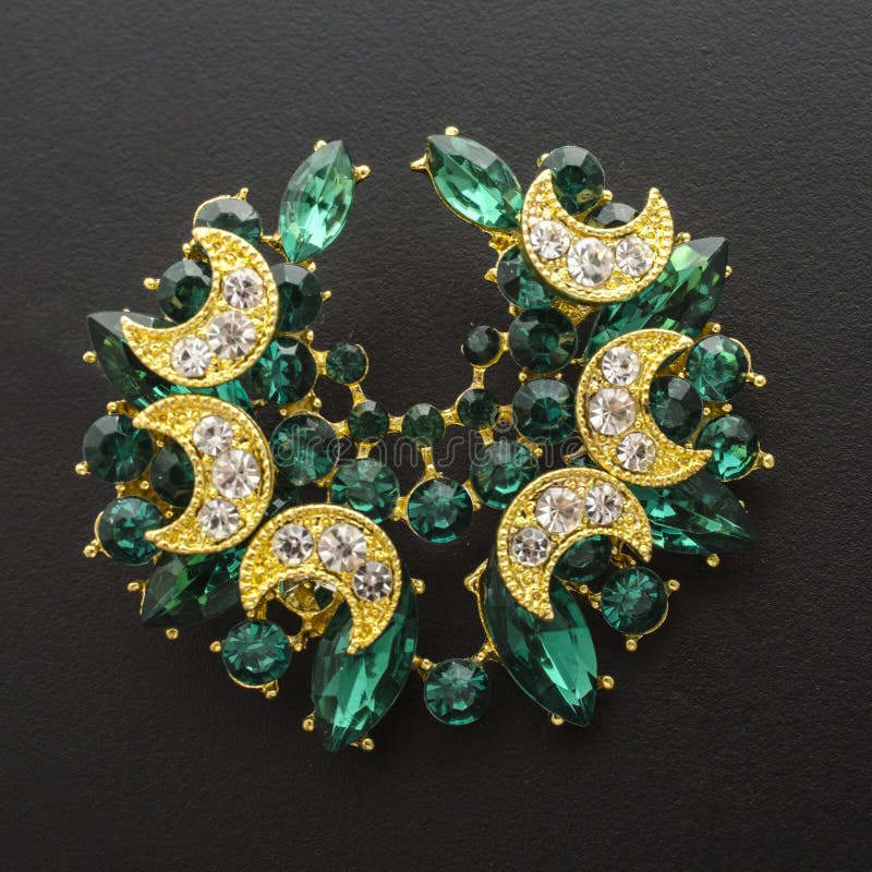 Golden Brooch with Emeralds and Diamonds Isolated on Black Stock Image ...