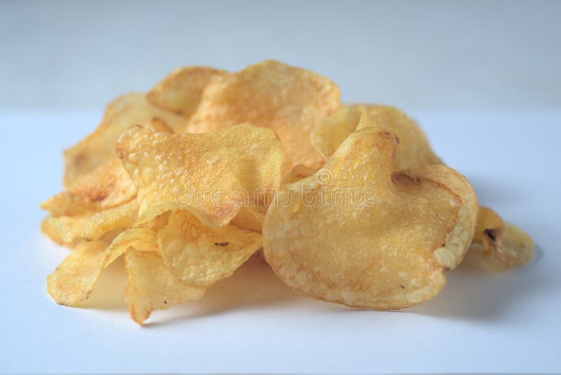 Golden-brown Potato Chips are Scattered on a White Surface Stock Image ...