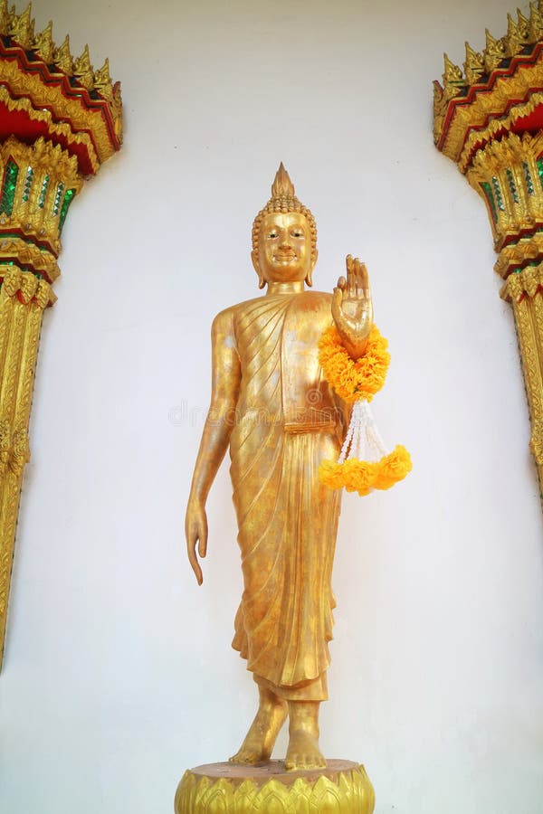 Golden Buddha Image in Waking Posture with an Offering Garland in Arm ...