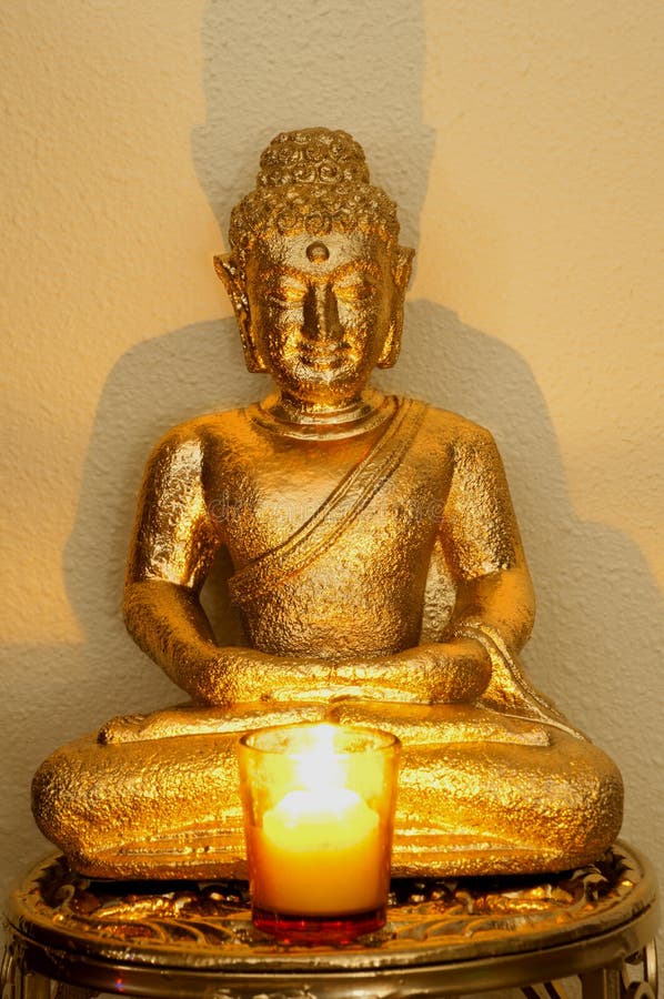 Golden Buddha Statue Closeup with Lit Candle Stock Image - Image of ...