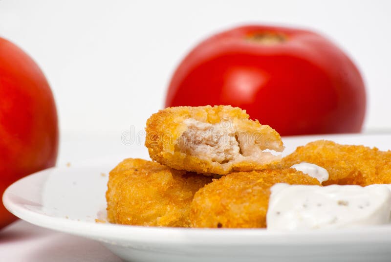 Golden Chicken Nuggets on Plate with Tomatoes Stock Photo - Image of ...