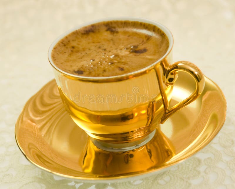 Golden coffee cup stock photo. Image of warm, tablecloths - 4945328