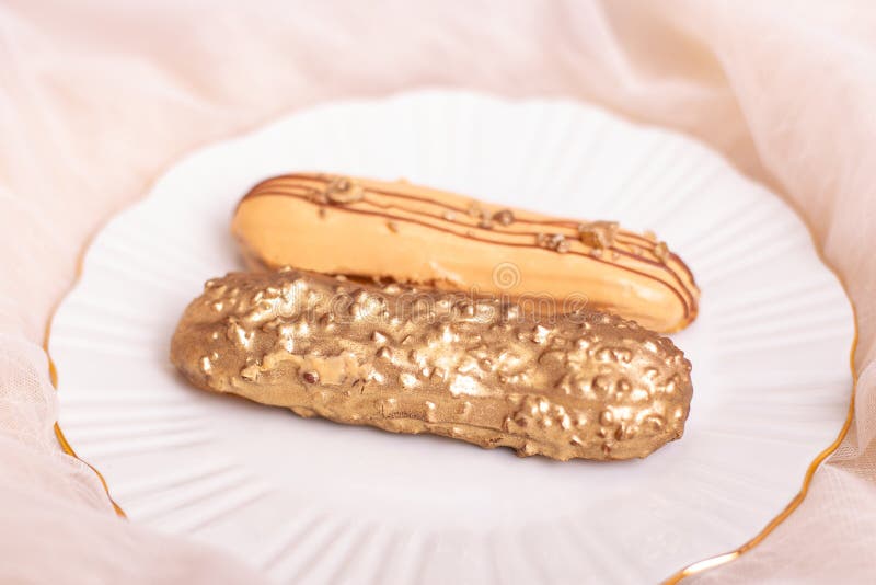 Golden Colored Eclairs on Plate Stock Image - Image of decor, meat ...