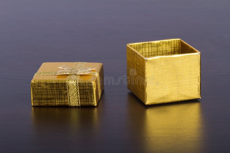 Golden Colored Gift Box on Table Stock Photo - Image of birthday, case ...