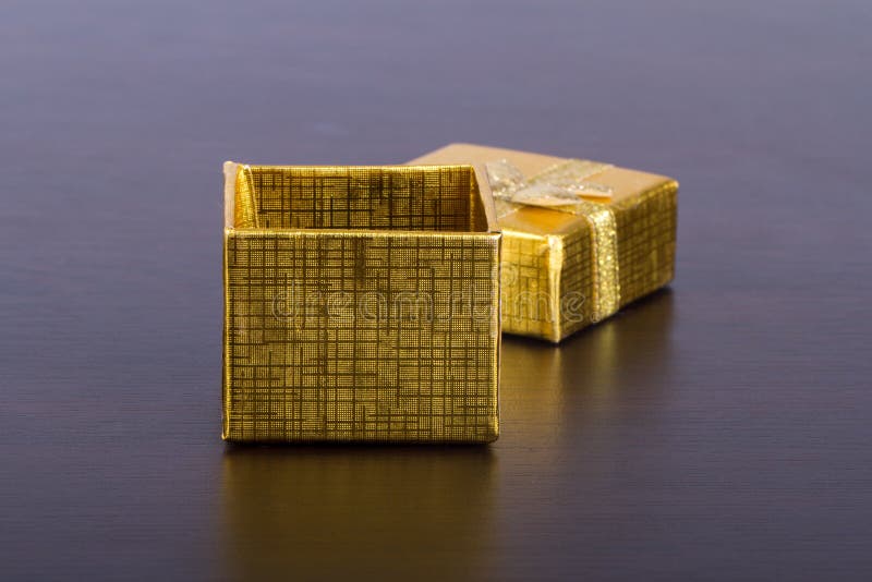 Golden Colored Gift Box on Table Stock Photo - Image of greeting, cube ...