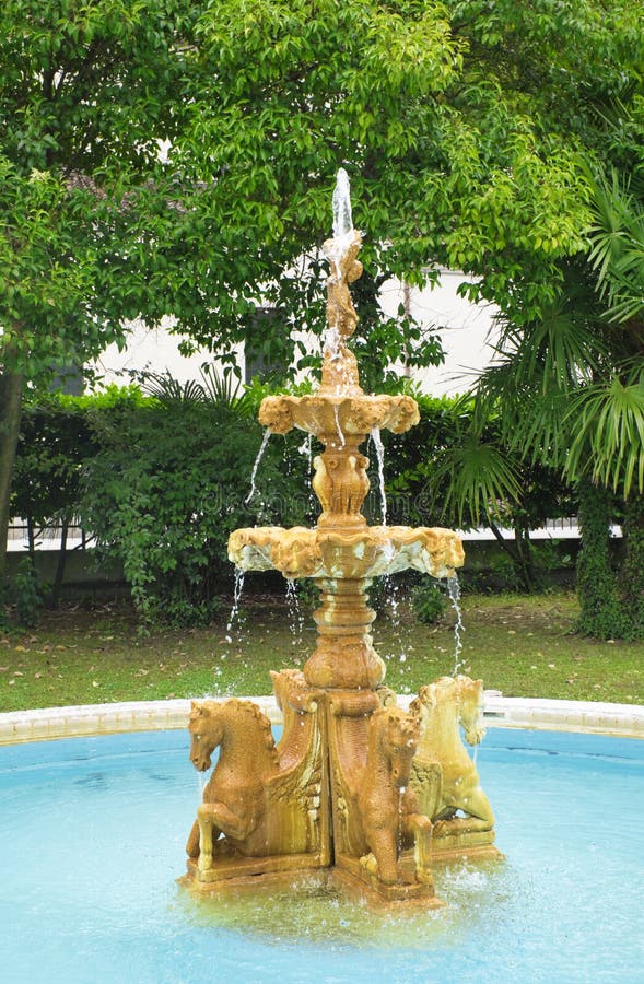 Golden Colored Monumental Fountain with Blue Water Fall Down Stock ...