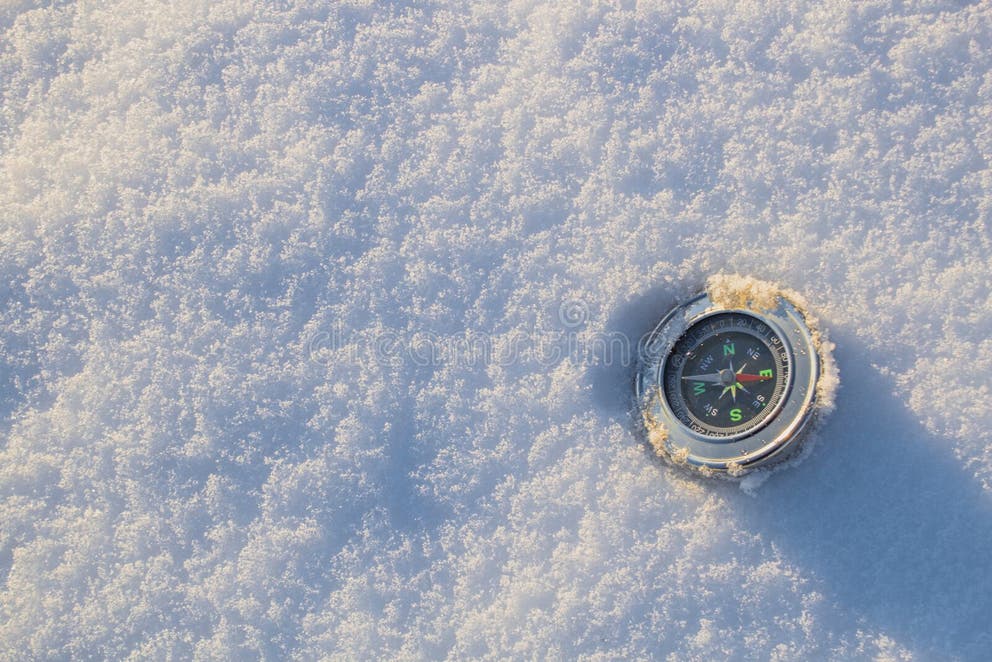Golden compass in the snow stock image. Image of tool - 237564937