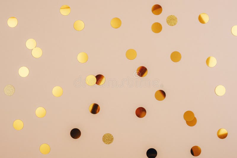 Golden Confetti Scattered on a Soft Beige Background, Top View Stock ...