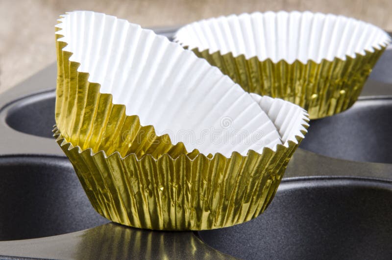 Golden Cup Cake Cases on a Baking Tin Stock Image - Image of round ...