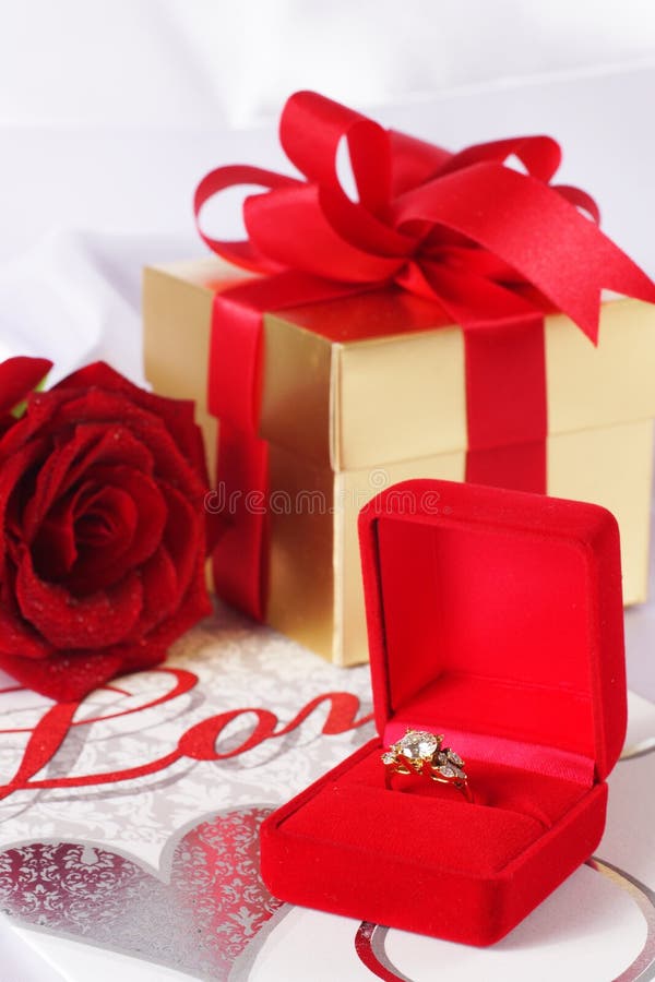 Engagement Ring in Box and Luxury Present in Red Ribbon Stock Photo ...