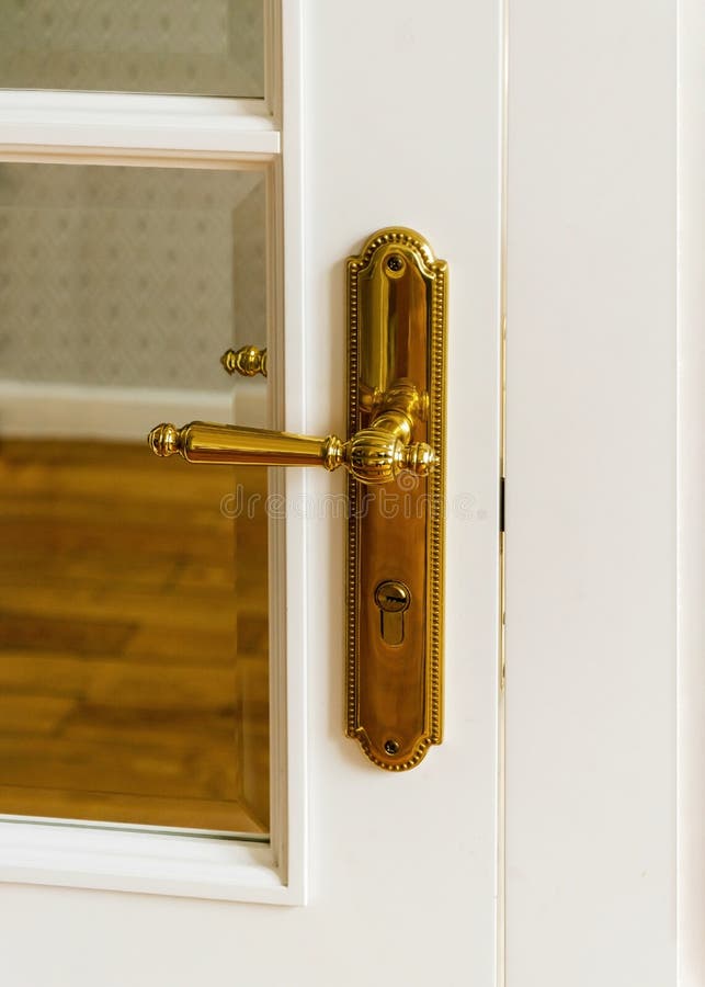 Golden Door Handle on Vintage White Door with Classic Design and Mirror ...
