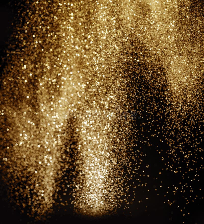 Golden Dust - Sparkling Gold Powder at the Black Background Stock Photo ...