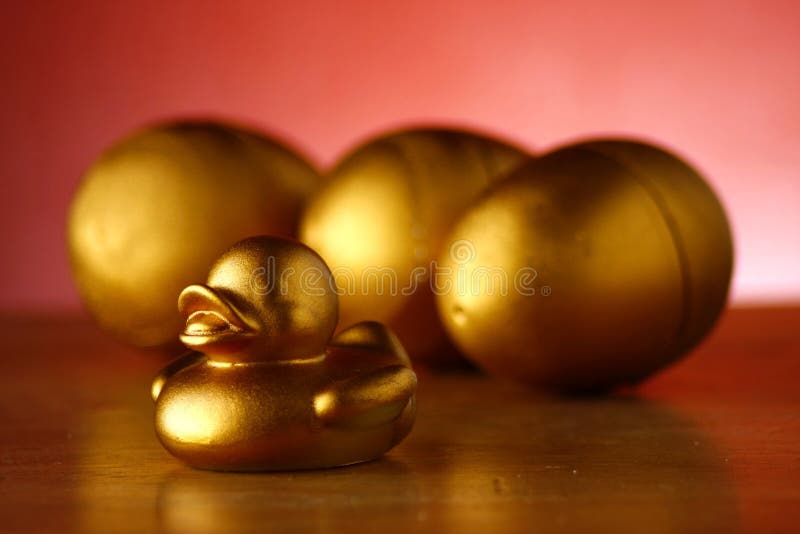 Golden Egg and Golden Duckling Stock Photo - Image of oval, financial ...