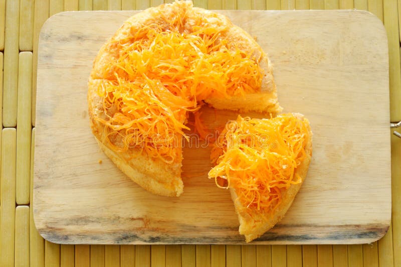 Golden Egg Threads Cake Cut for Piece on Chop Block Stock Image - Image ...