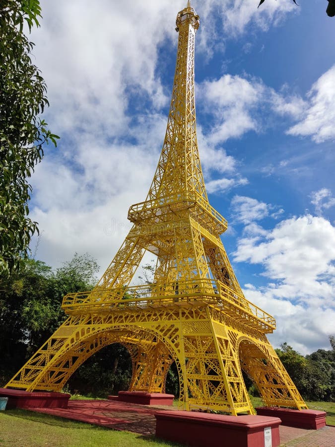 Golden Eifel Tower in the Park with a Cloudy Blue Sky Stock Image ...