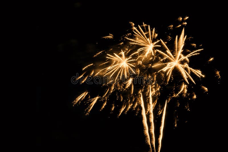 Golden firework on black. stock photo. Image of fire - 140448954