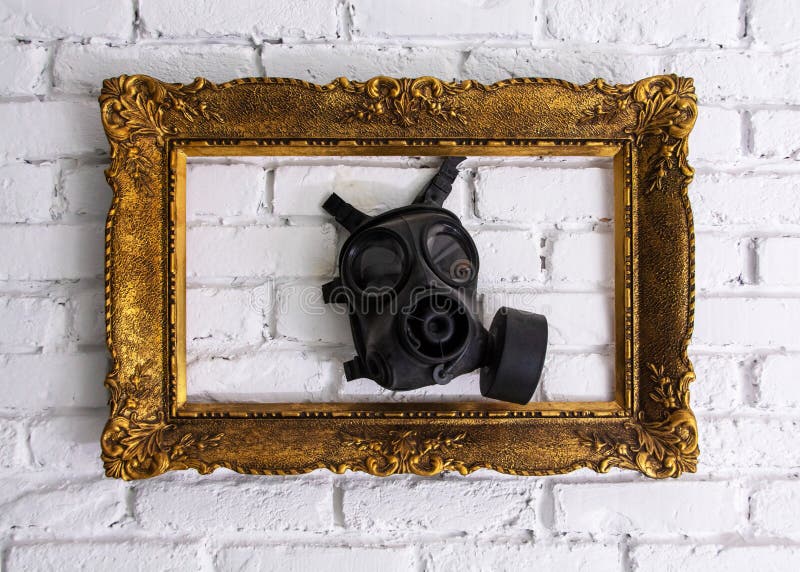 Golden Frame with Black Gas Mask on White Brick Wall Stock Photo ...