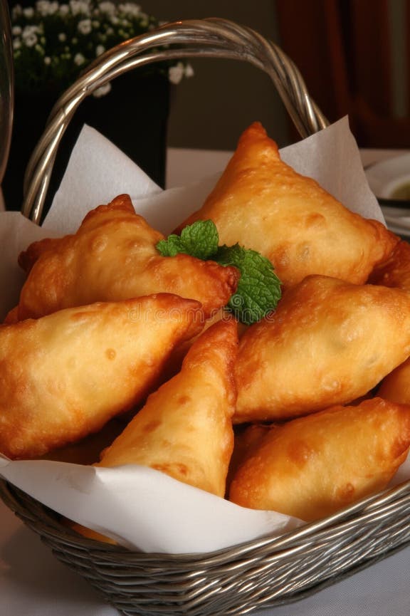Golden Fried Samosas in Basket with Mint Garnish Stock Photo - Image of ...