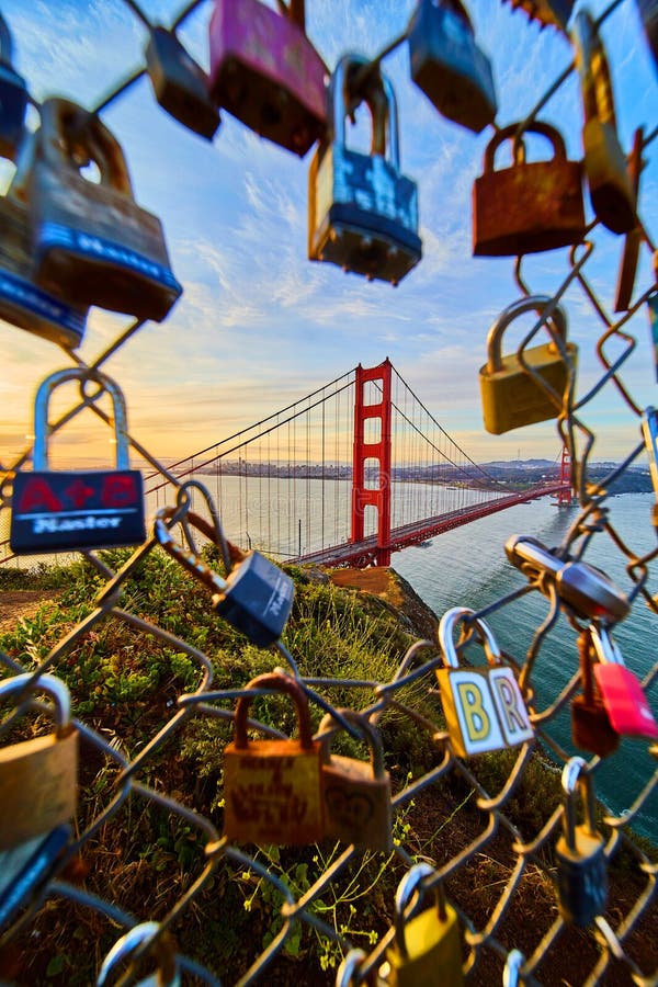 Chain Link Fence Covered in Locks with Hole Revealing Golden Gate ...