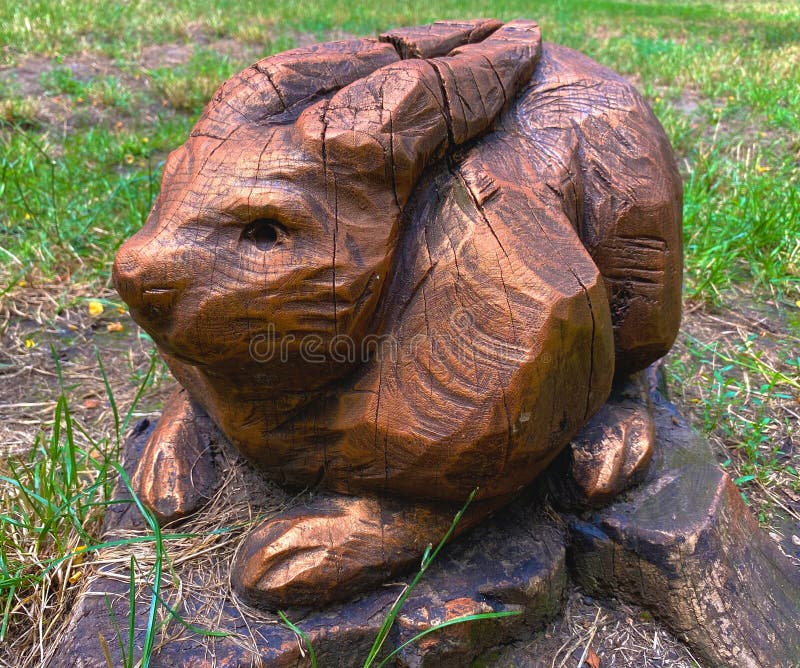Golden hare on a stump stock photo. Image of statue - 283427654
