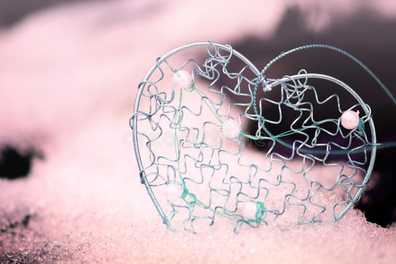 Golden heart shape in snow stock image. Image of gift - 107433575