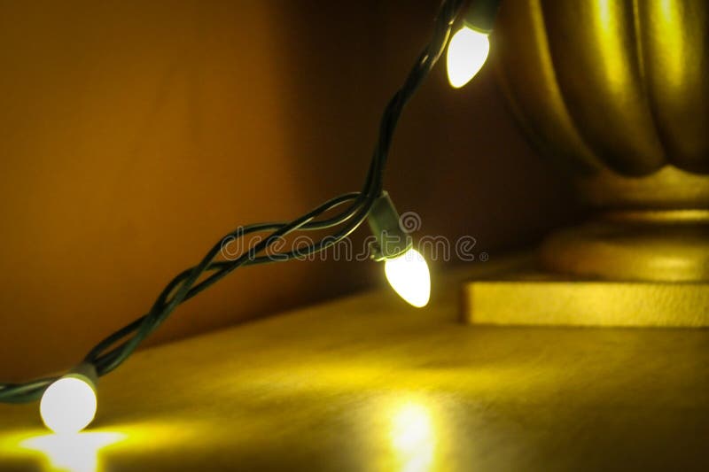 Golden Holiday String Lights Close Up with Gold Bokeh Reflection ...