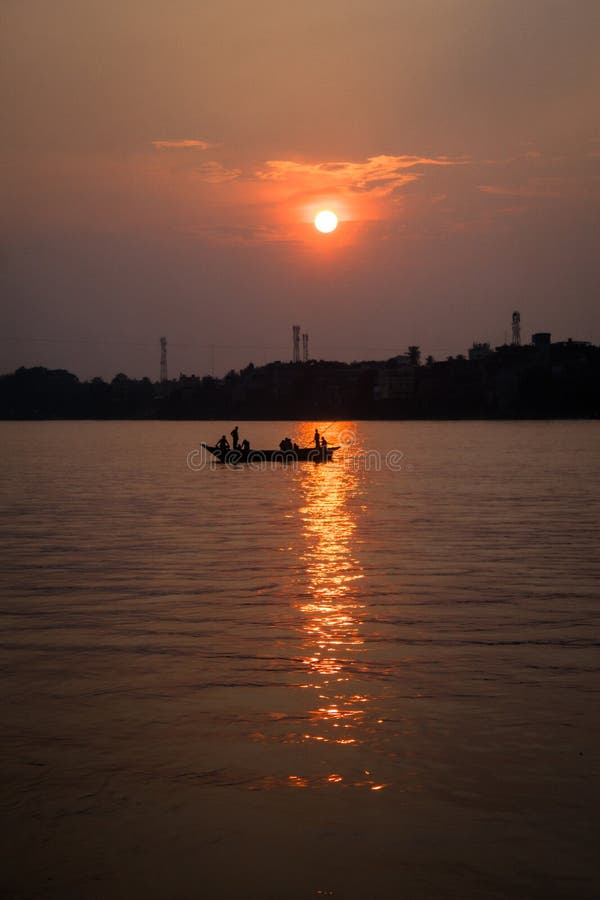 Golden Hour Reflection on the River and a Boat Crossing the Reflection ...