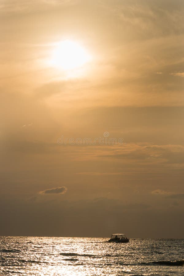Golden Hour at Sea with Boat, Clouds and Sun Stock Image - Image of ...
