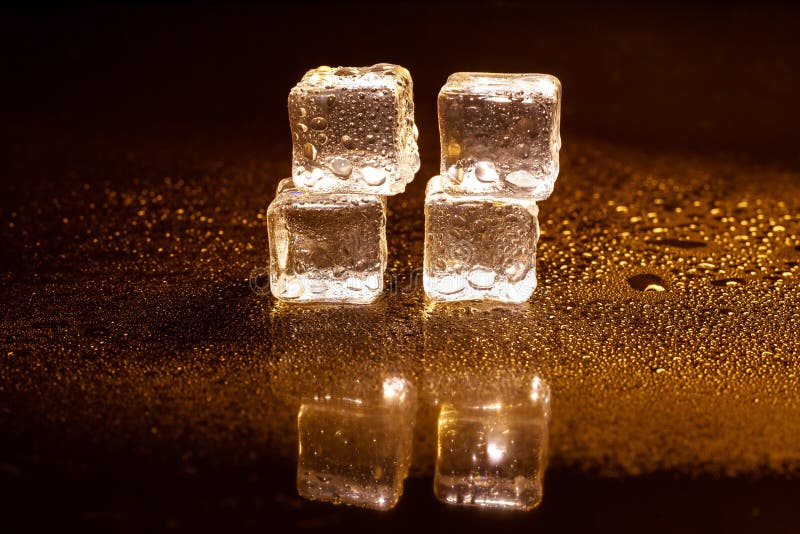 Golden Ice Cubes Reflection on Black Table Stock Photo - Image of black ...