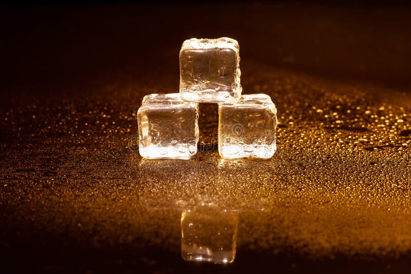 Golden Ice Cubes Reflection on Black Table Stock Image - Image of ...