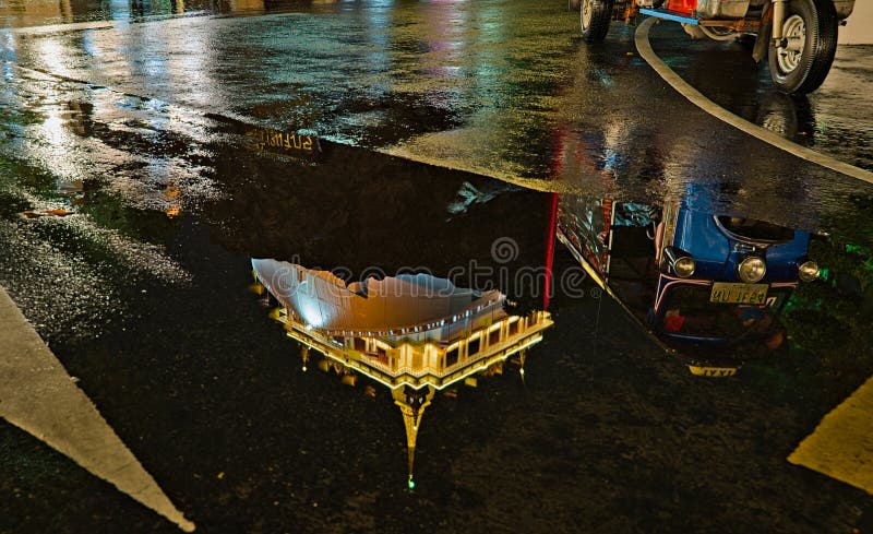 Golden Mount Reflection in a Puddle and a Tuk Tuk Stock Photo - Image ...