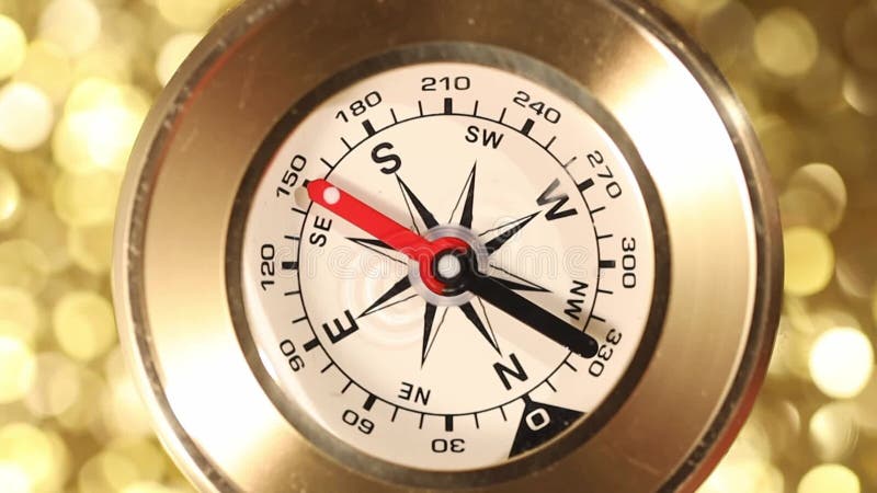 An Old Golden Compass with the Compass Arrow Spinning Wildly. Concept ...