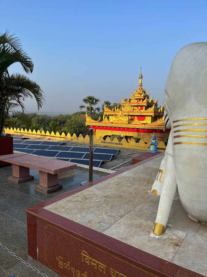 Golden Pagoda and Elephant Statue with Solar Panels in Temple Complex ...