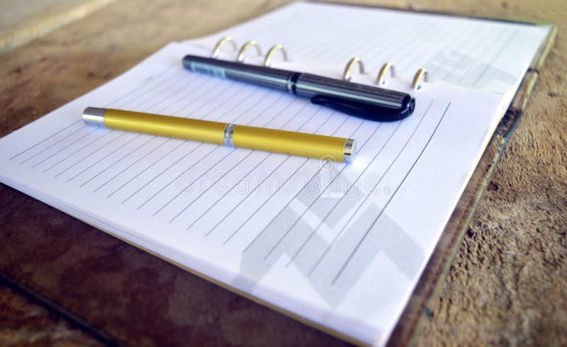 Golden Pen on Note Book stock photo. Image of empty, spiral - 94109208