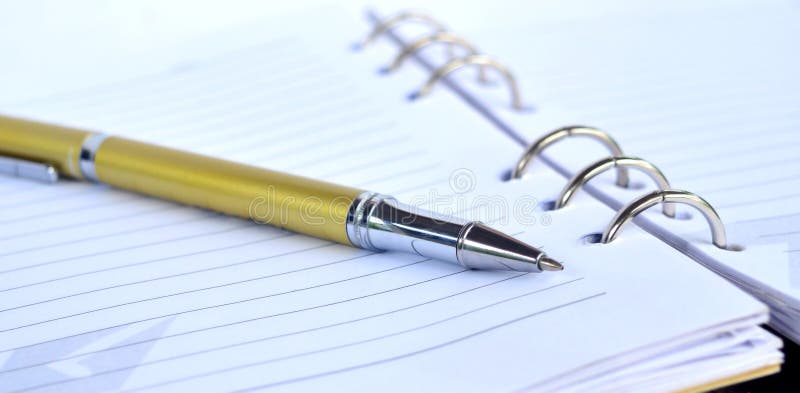 Golden Pen on note pad stock image. Image of executive - 93844075