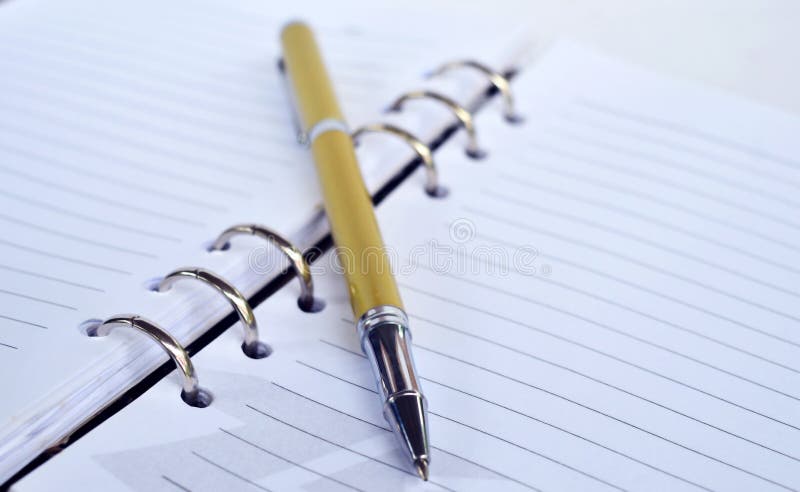 Golden Pen on note pad stock image. Image of checklist - 93844111
